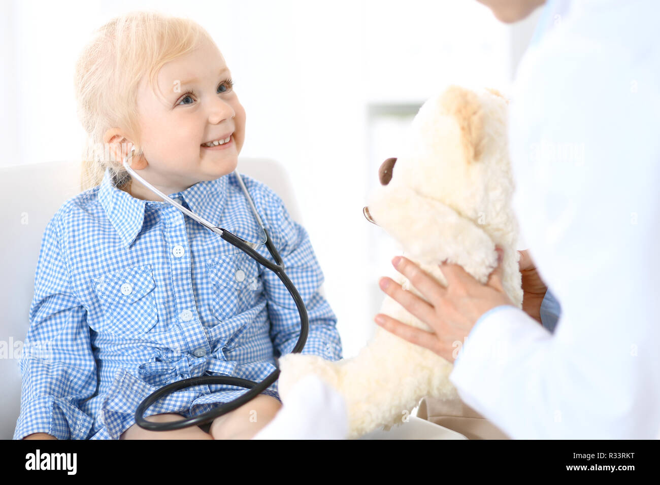 Doctor and a little blonde girl. Medicine and healthcare concept Stock ...