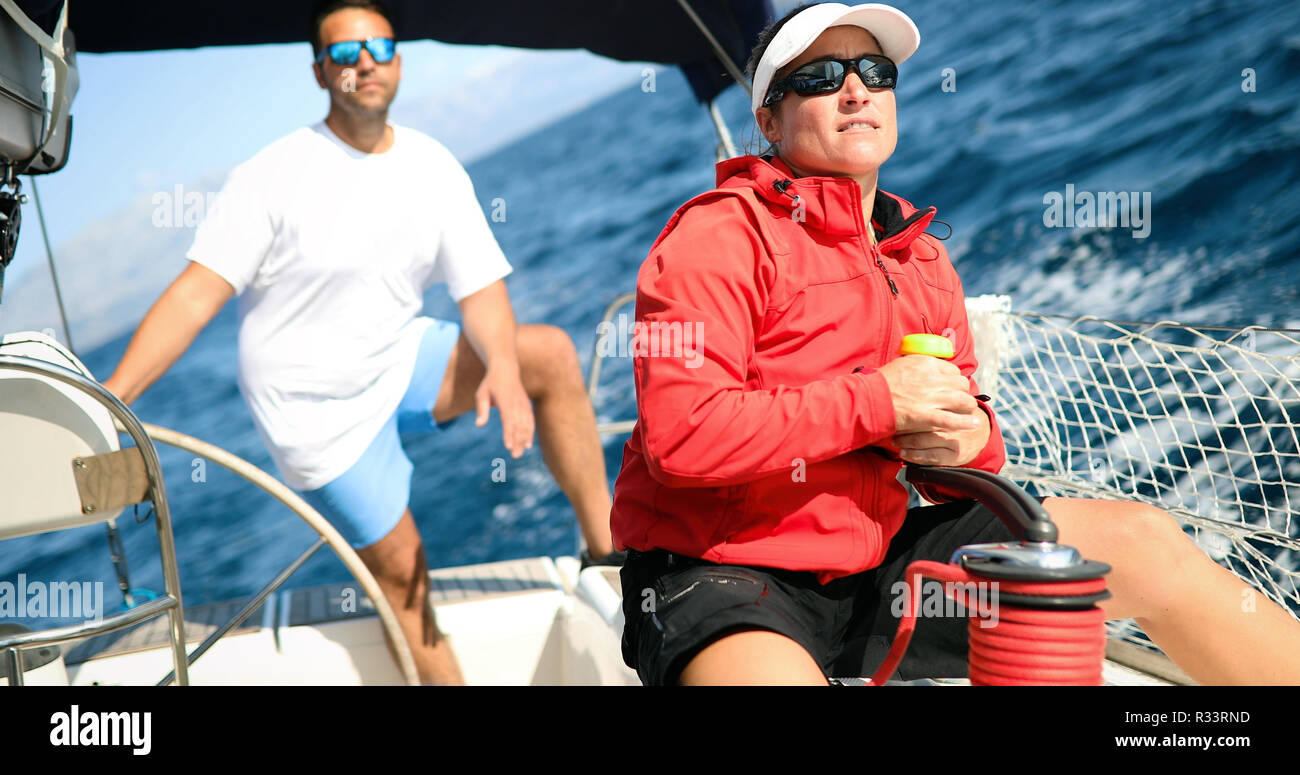Young strong beautiful woman sailing the boat Stock Photo - Alamy