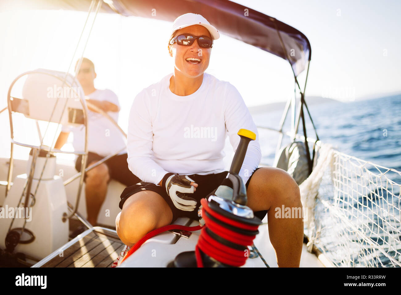 Attractive strong woman sailing with her boat Stock Photo - Alamy