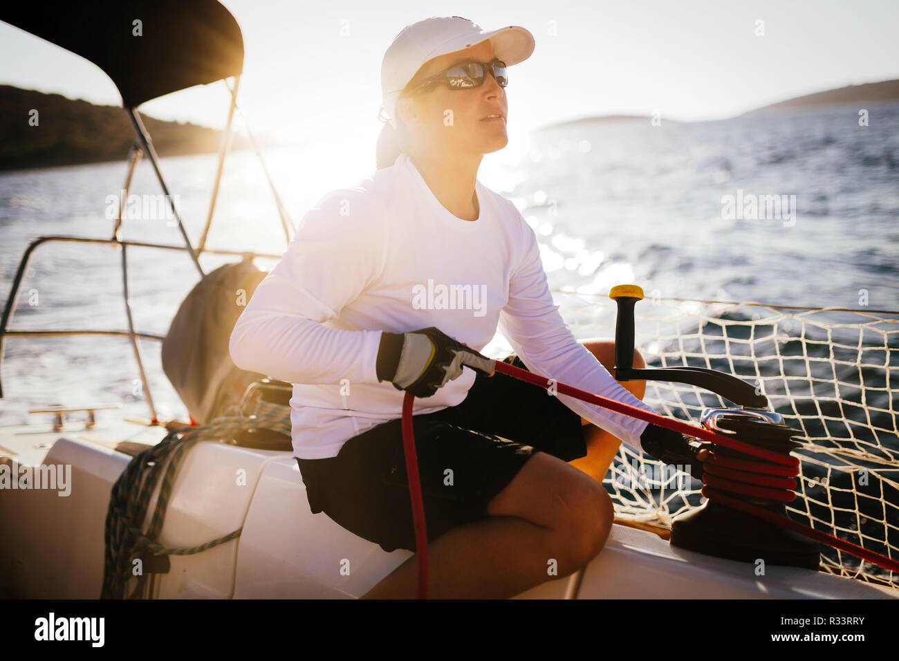 Attractive strong woman sailing with her boat Stock Photo - Alamy