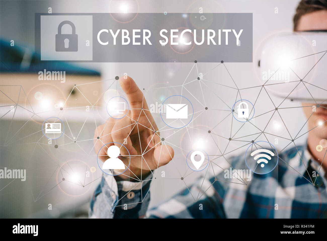 man in virtual reality headset pointing at cyber security signs in room ...