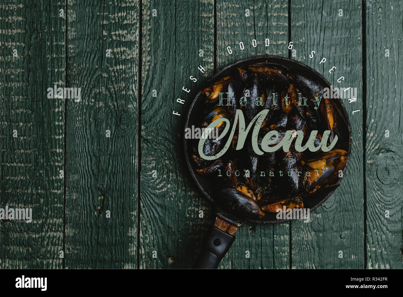 Top view of cooked mussels with shells served in pan on wooden table ...