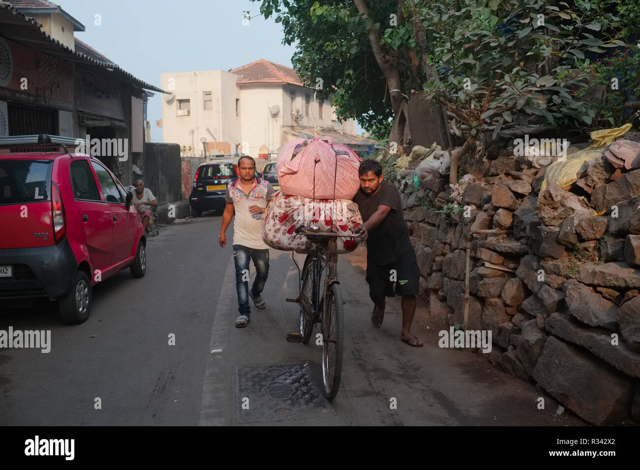 A dhobi or washerman of the North Indian Kanaujia caste delivering ...