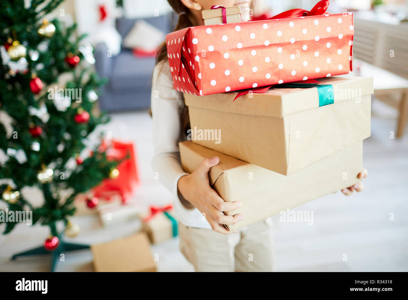 Stack of big and small packed boxes with Christmas gifts held by little ...