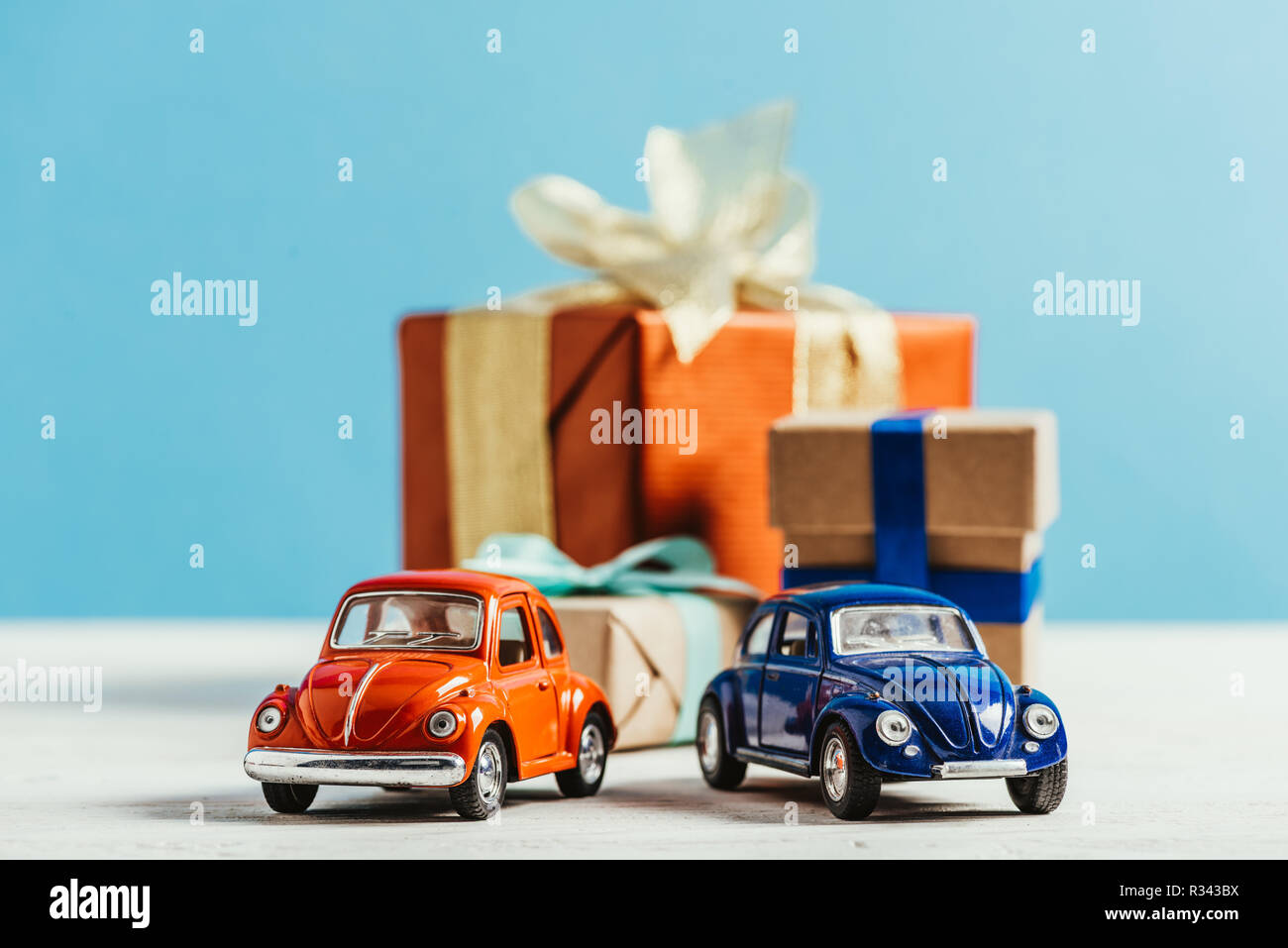 close-up shot of toy cars with christmas gift boxes on blue background ...