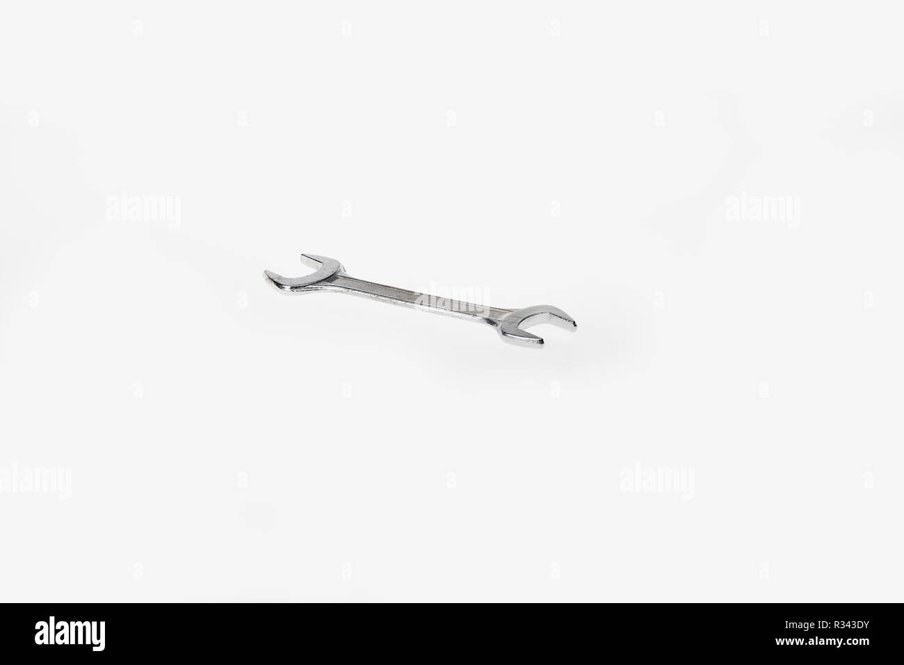 Silver colored wrench tool isolated on white Stock Photo - Alamy