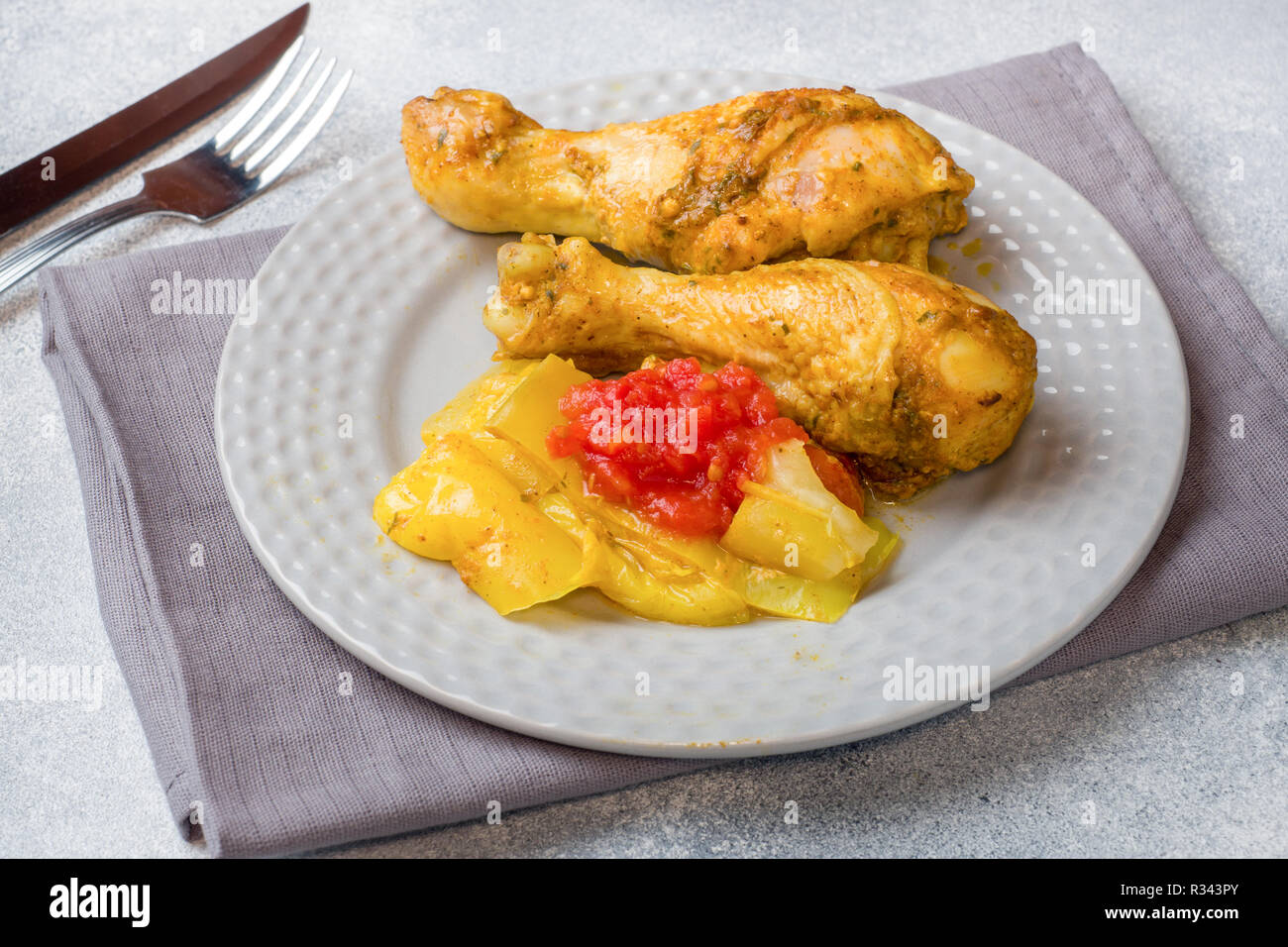 Baked chicken leg Shin with vegetables tomato zucchini on a plate Stock ...
