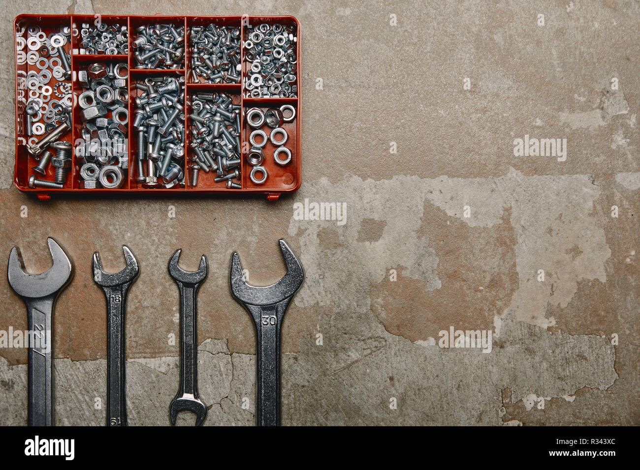 Flat lay with Set of wrenches tools and box of screws on the background ...