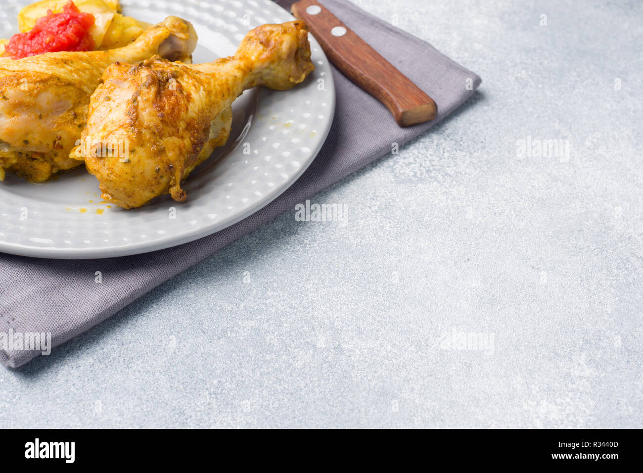 Baked chicken leg Shin with vegetables tomato zucchini on a plate Stock ...
