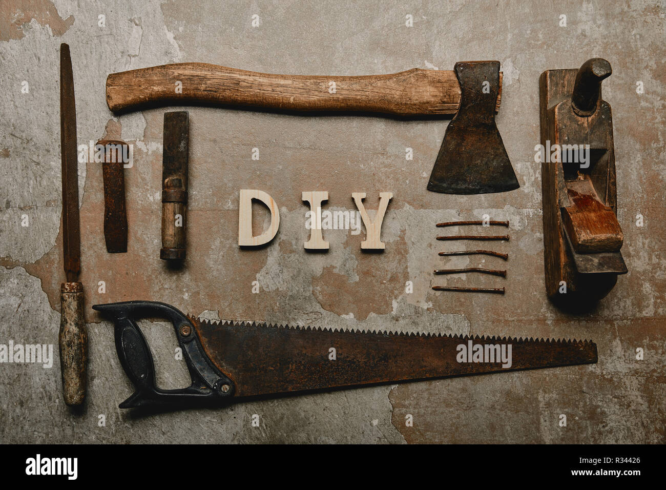 Flat lay with set of carpentry tools and diy sign on old surface Stock ...
