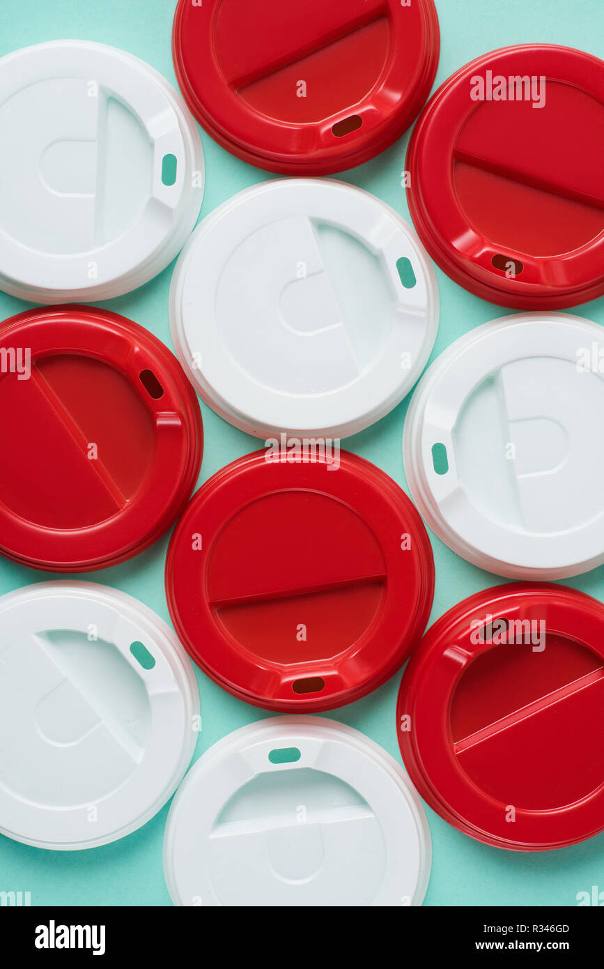 Top view of red and white disposable lids for drink arranged on blue ...