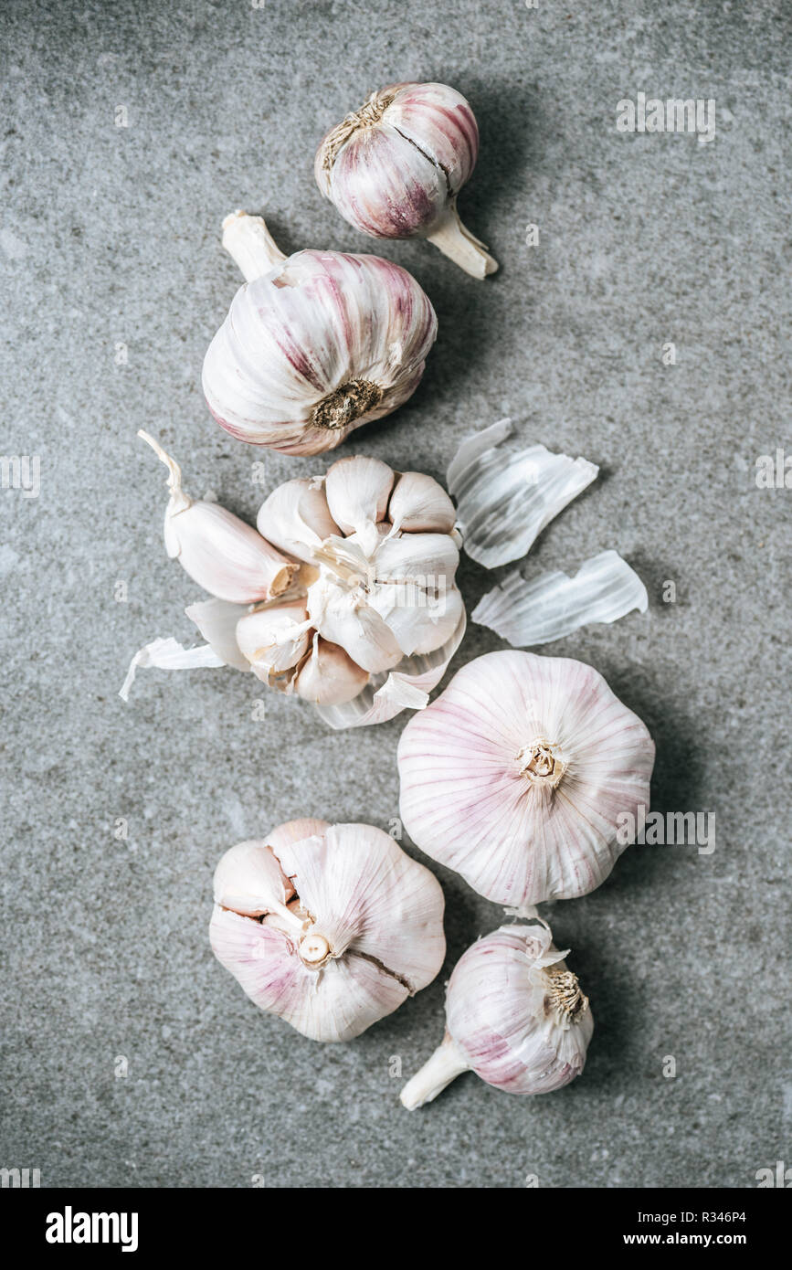 Top view of ripe garlic bulbs and husk on grey background Stock Photo ...