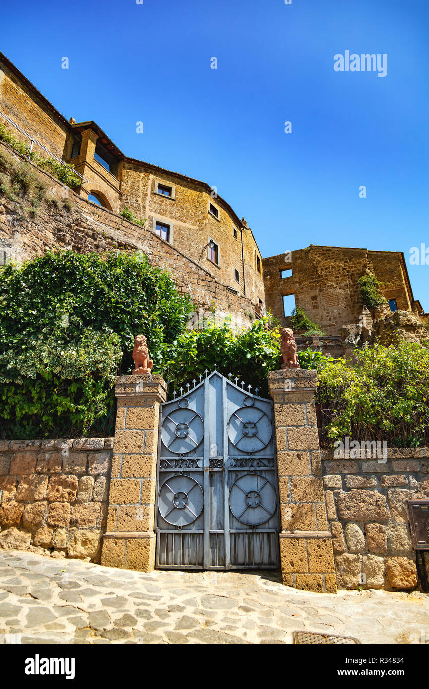 Facade of a stone house with an iron gate of the village Civita di ...