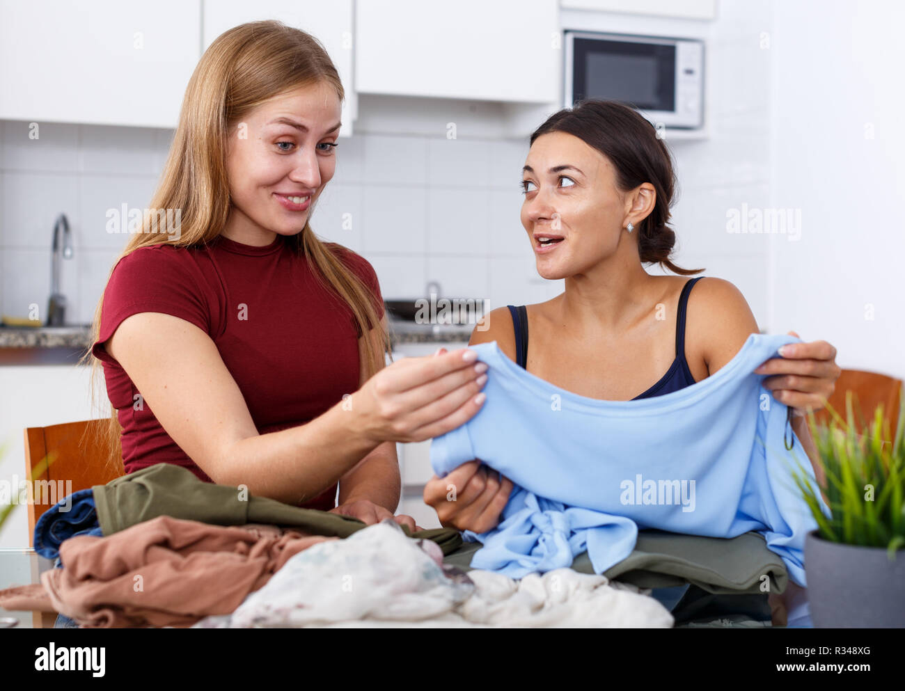 Two women clothes dressing hi-res stock photography and images - Alamy