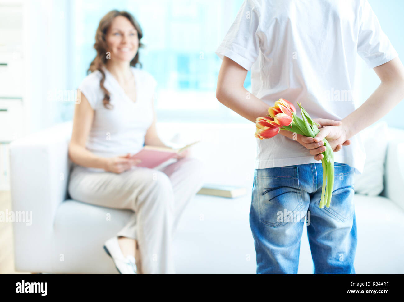 Boy holding flower behind back hi-res stock photography and images - Alamy