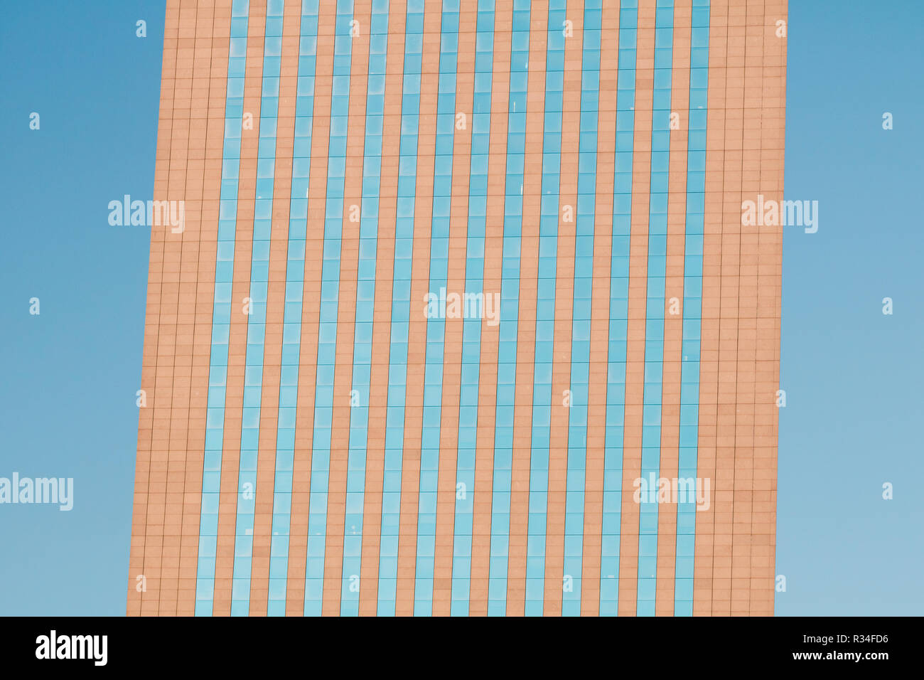 Fragment of a modern skyscraper against the blue sky. Abstract ...