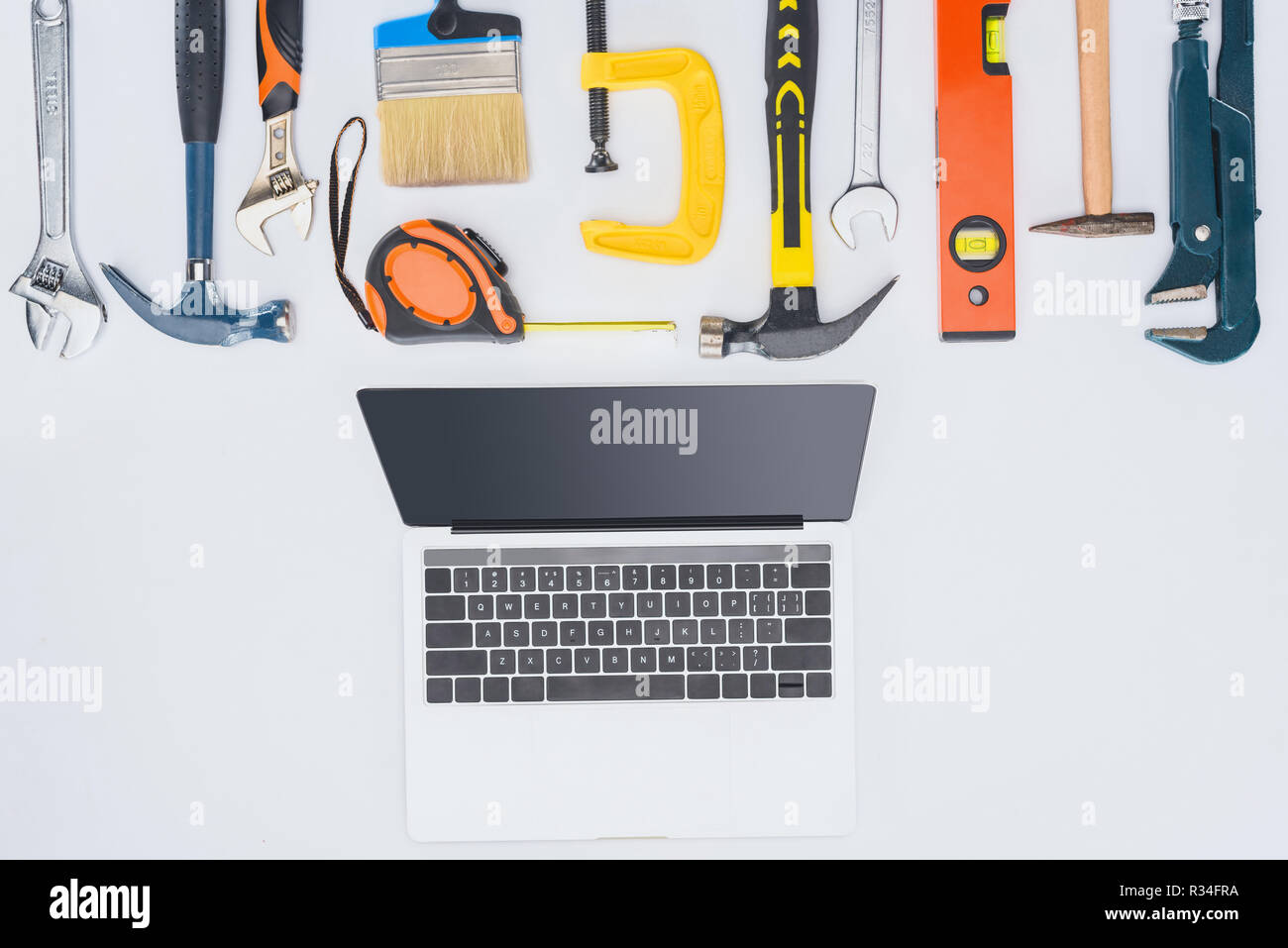 top view of laptop with different tools lying on white Stock Photo - Alamy