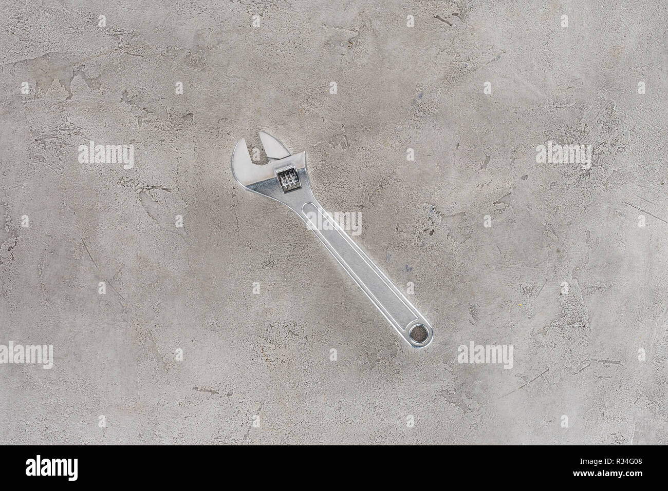 top view of pipe wrench lying on concrete surface Stock Photo - Alamy