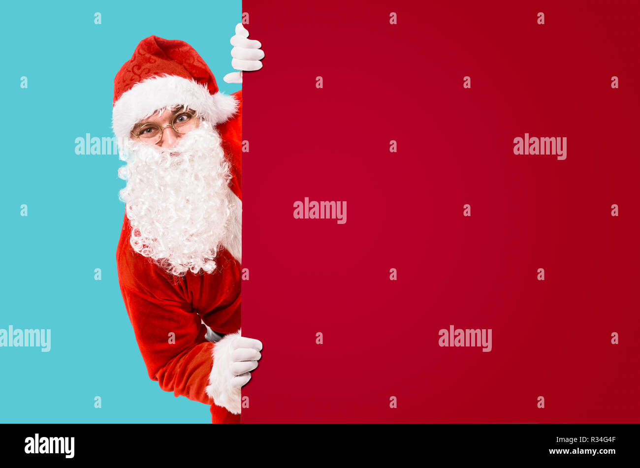 Santa Claus with colorful advertisement board Stock Photo - Alamy