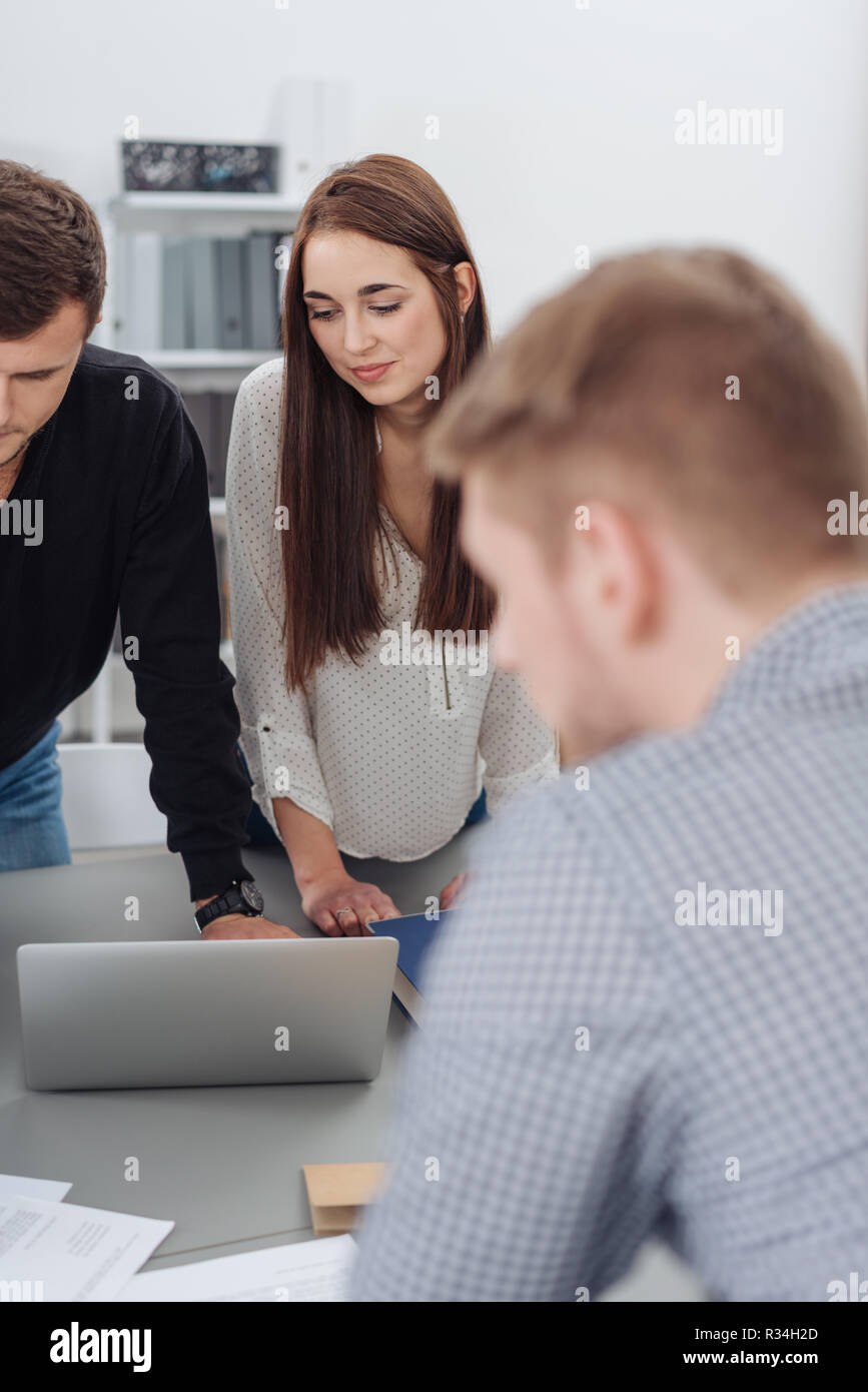Business people grouped around laptop hi-res stock photography and ...