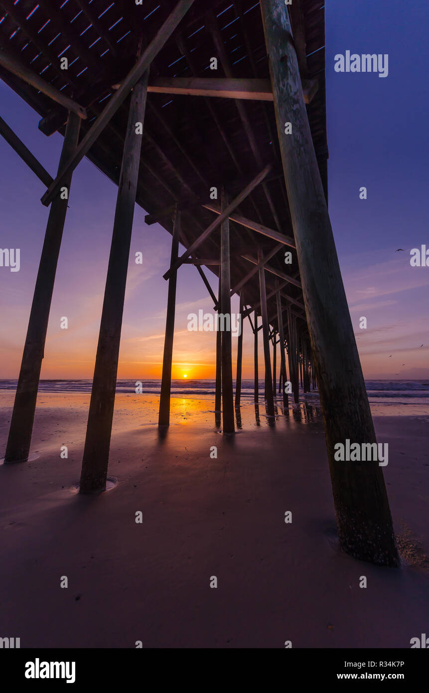 Beautiful sky during sunset at a pier on the beach Stock Photo - Alamy