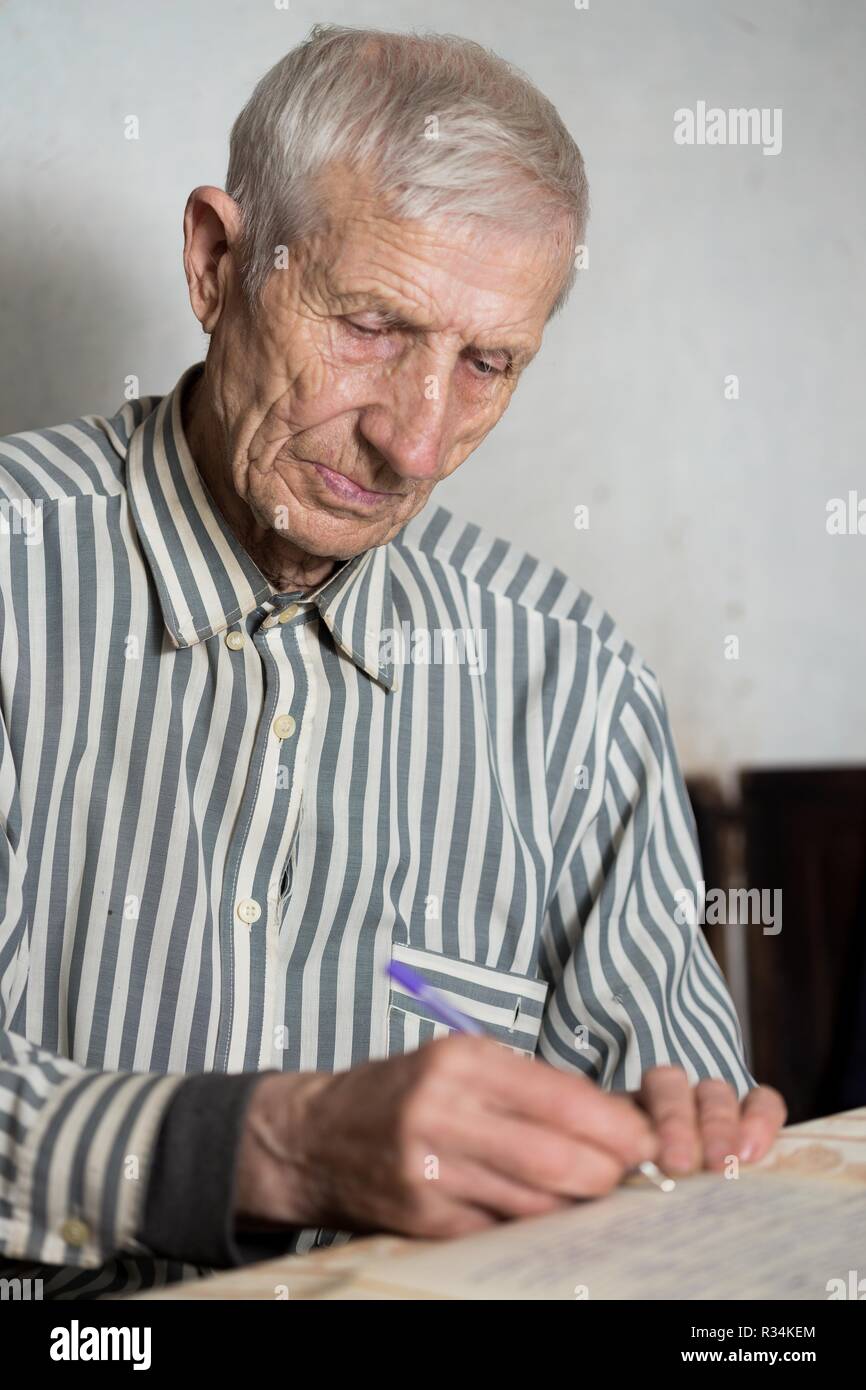 Older person writing a book hi-res stock photography and images - Alamy