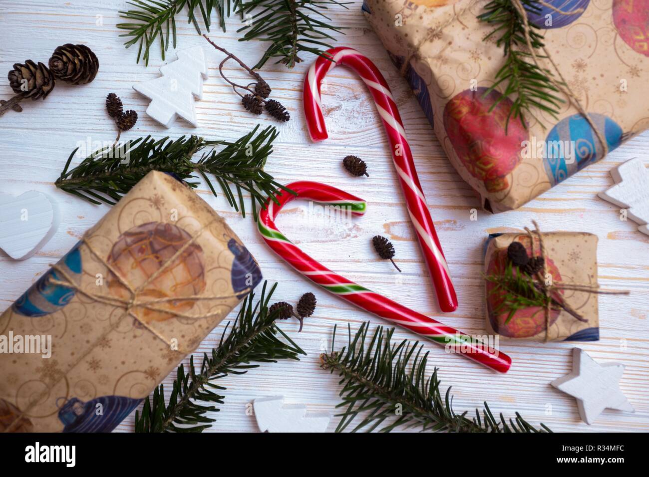 Christmas backgrounds. Gifts and candy caner on the wooden background ...