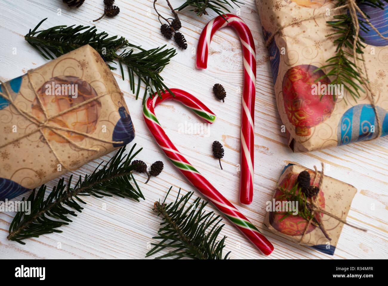 Christmas backgrounds. Gifts and candy caner on the wooden background ...
