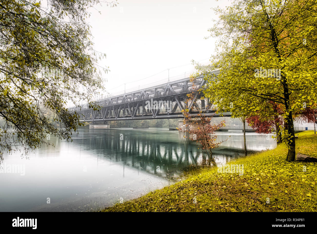 iron bridge on Ticino river in flood during the rainy season with milky ...