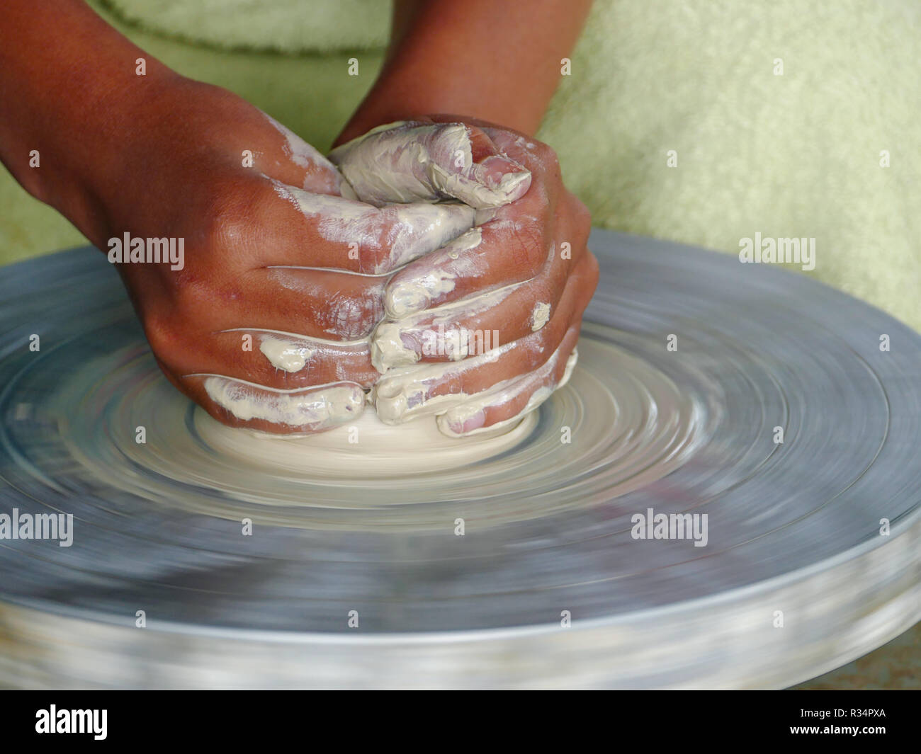 hands making pottery on the potter's wheel Stock Photo - Alamy