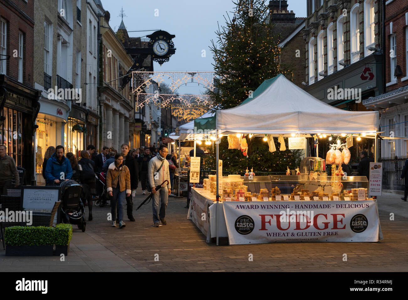Shoppers looking at a fudge stall on Winchester High Street with a ...