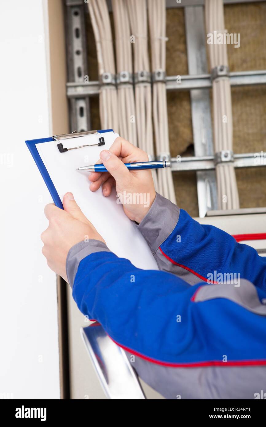 Factory worker holding paper clipboard hi-res stock photography and ...