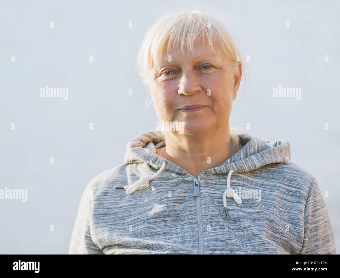 Portrait of beautiful aged woman in the seashore. Selective soft focus ...