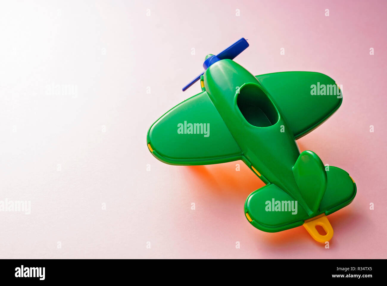 Children's toy green plane on a pink gradient background Stock Photo ...