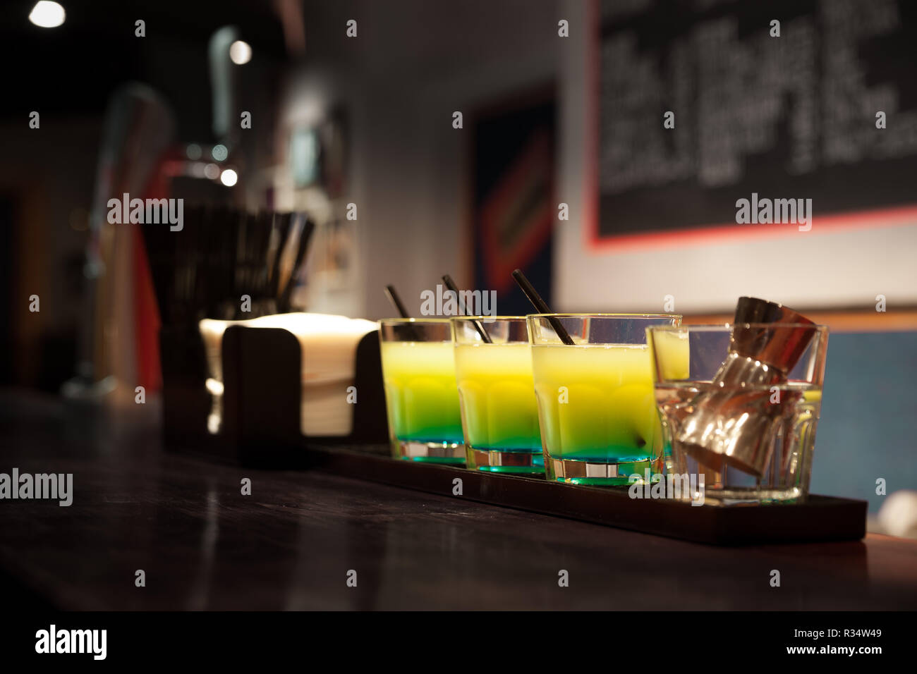 three glasses of cocktails are on the bar Stock Photo - Alamy
