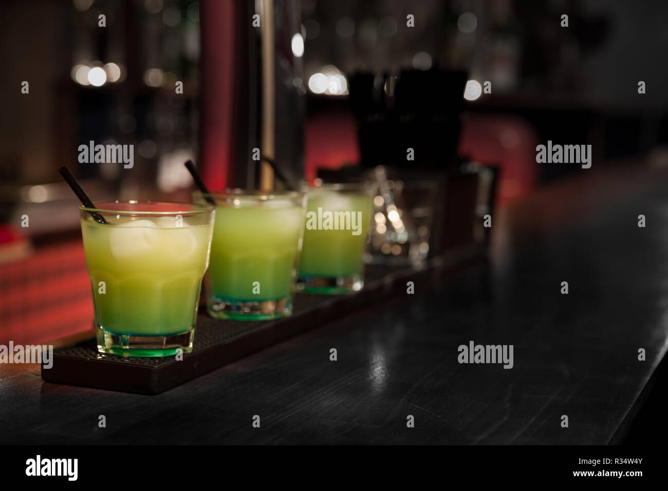three glasses of cocktails are on the bar Stock Photo - Alamy