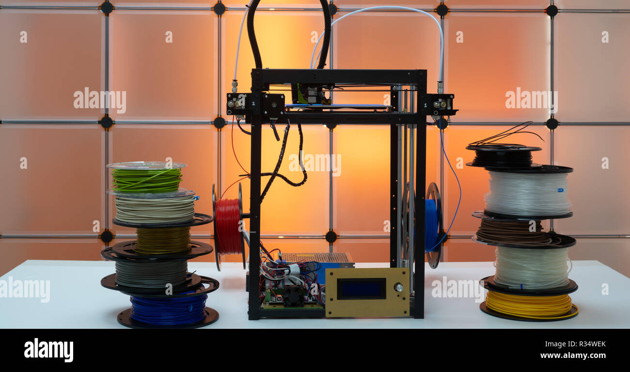 3d printer and plastic filament on color background Stock Photo - Alamy