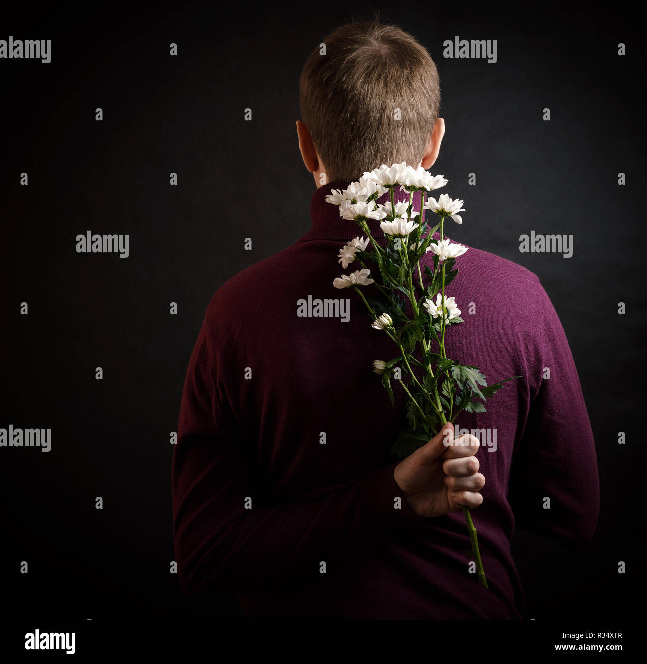 Man with flowers behind his hi-res stock photography and images - Alamy