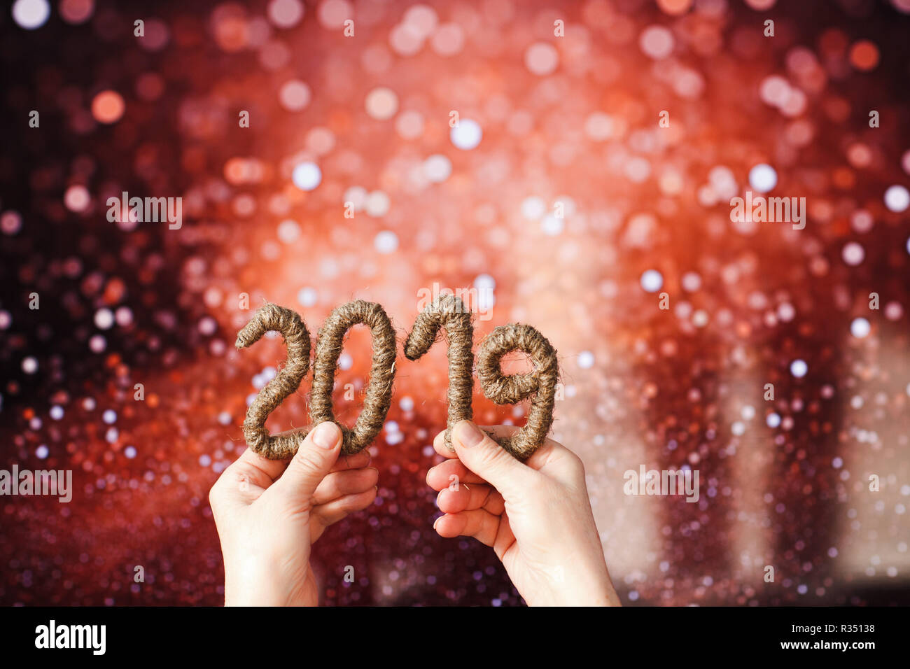 2019 numbers in hands and bokeh background. Christmas and happy new ...