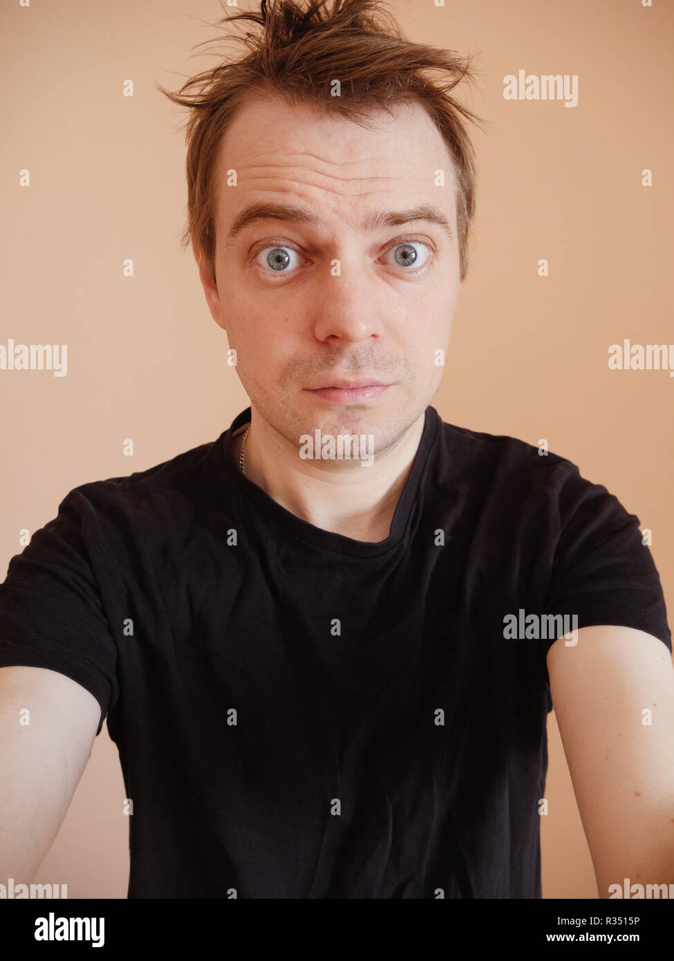 Sleepy young man makes a self-portrait Stock Photo - Alamy