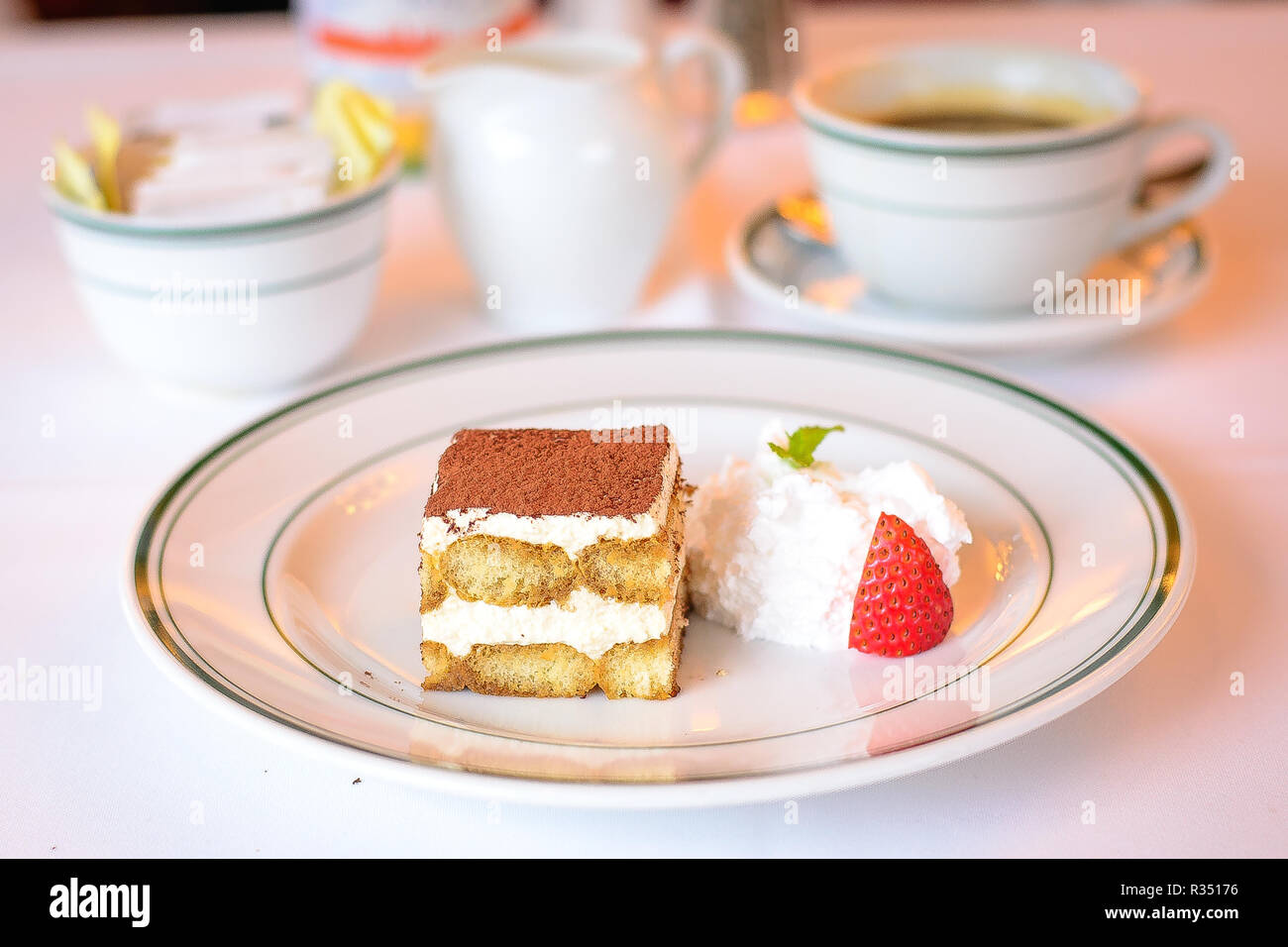 Tiramisu dessert and with fresh cream and strawberry and long black ...