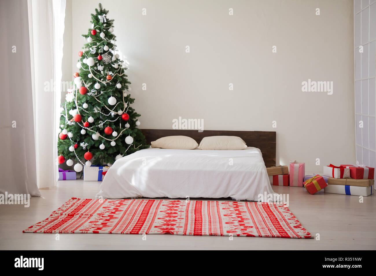 Interior bedroom with bed and Christmas tree new year holidays gifts ...