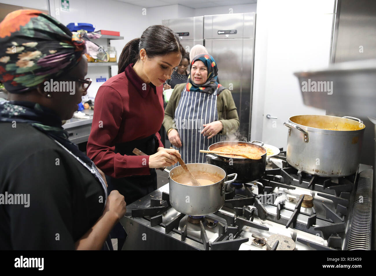 The Duchess of Sussex helps prepare food during her to visit the Hubb ...