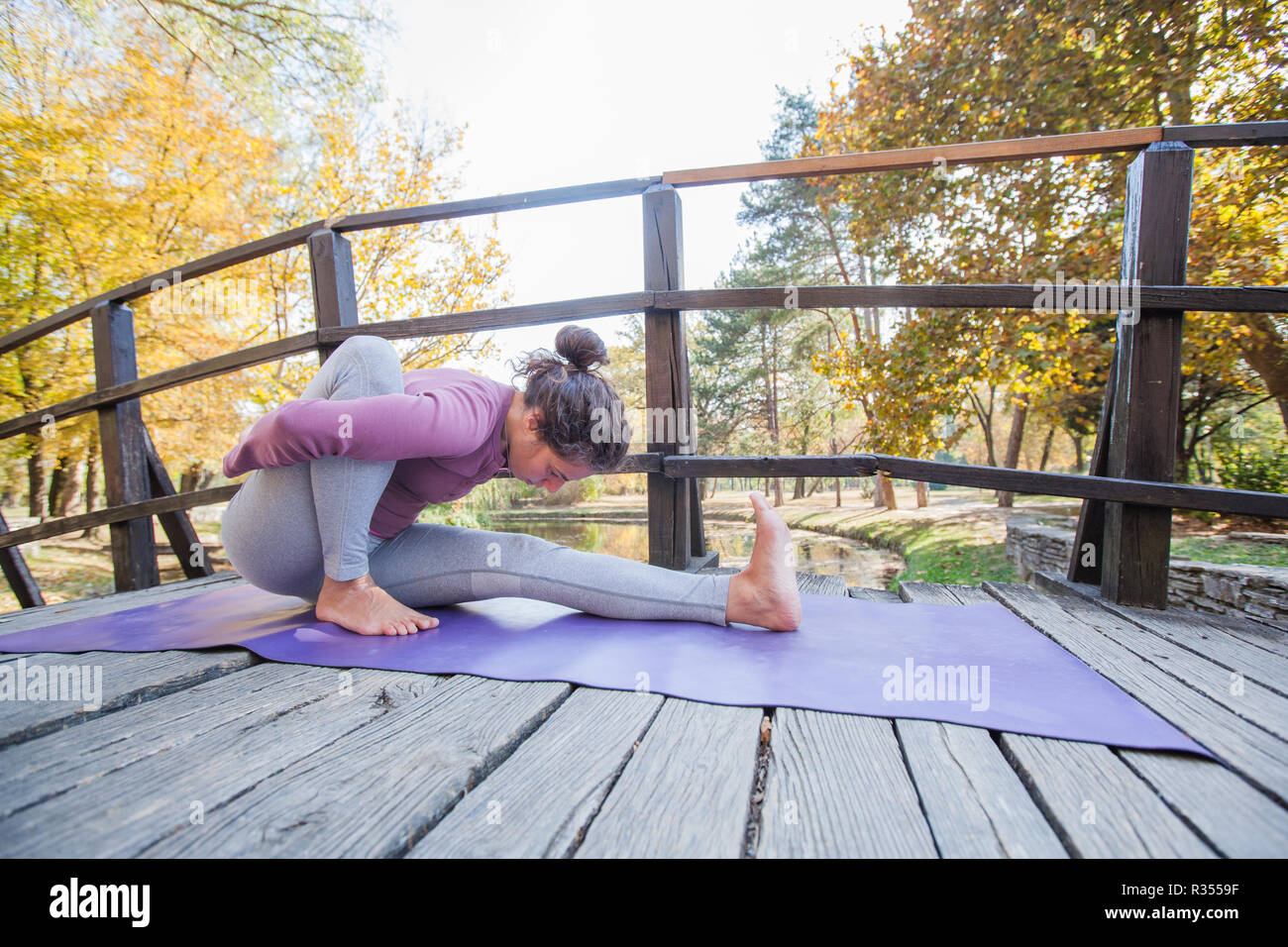 Young Sporty Woman Doing Yoga Exercise, Head To Knee Forward Bend Pose ...