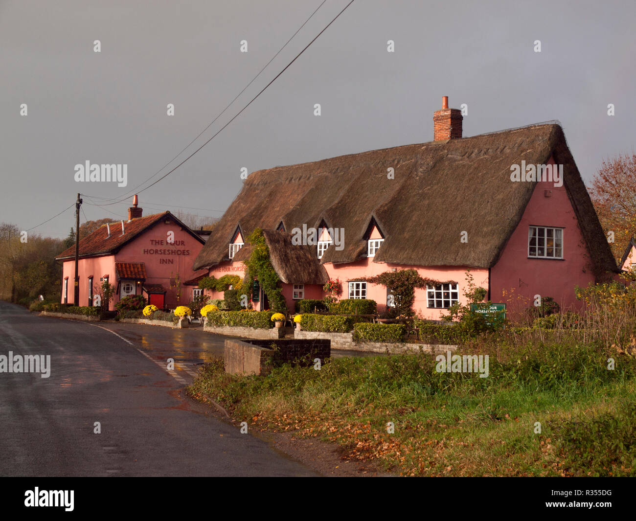 A pink painted, thatch roofed pub in Suffolk Stock Photo - Alamy