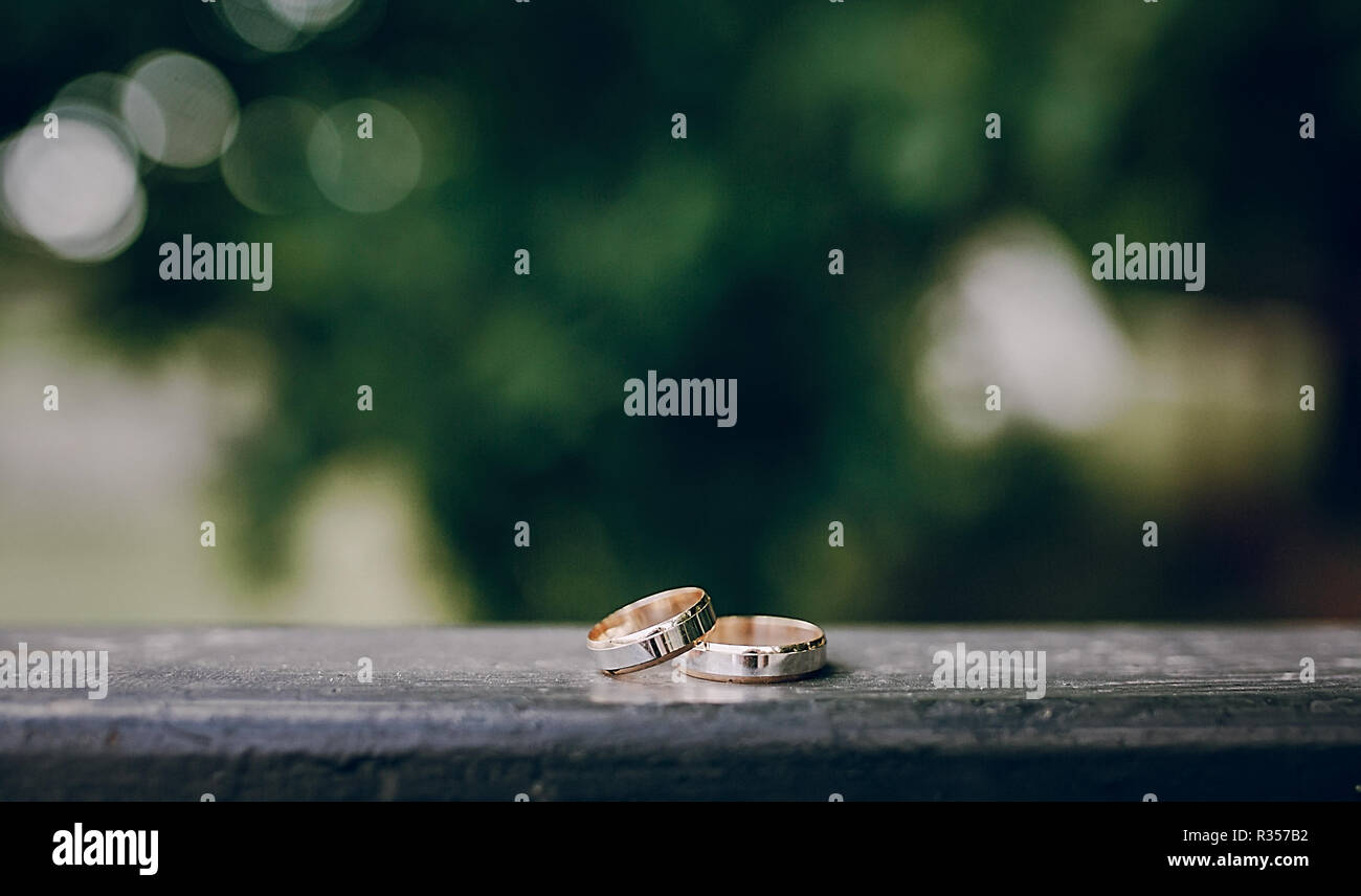 Wedding rings on wooden surface hi-res stock photography and images - Alamy
