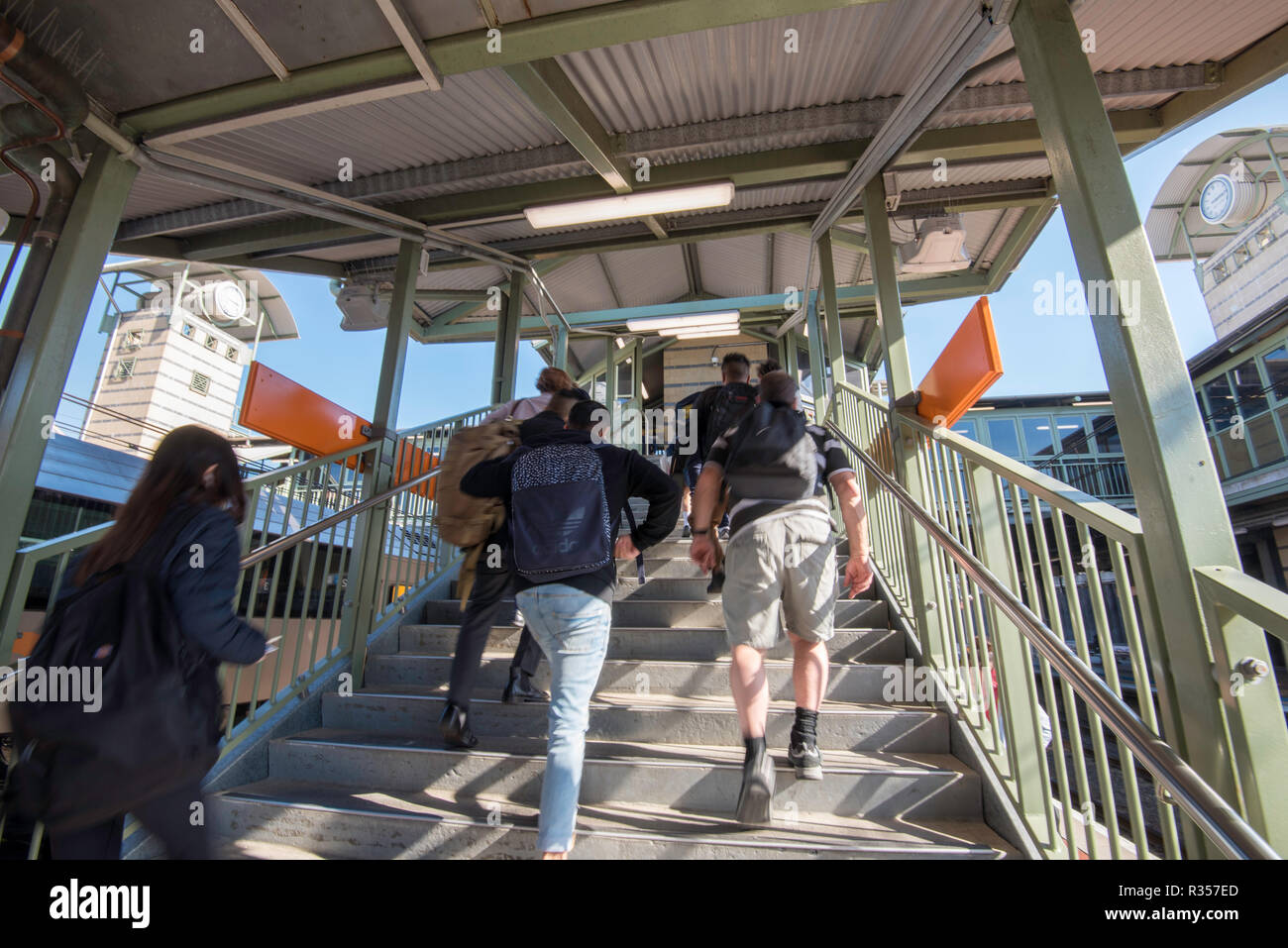 Rail passengers disembarking and walking up stairs hi-res stock ...