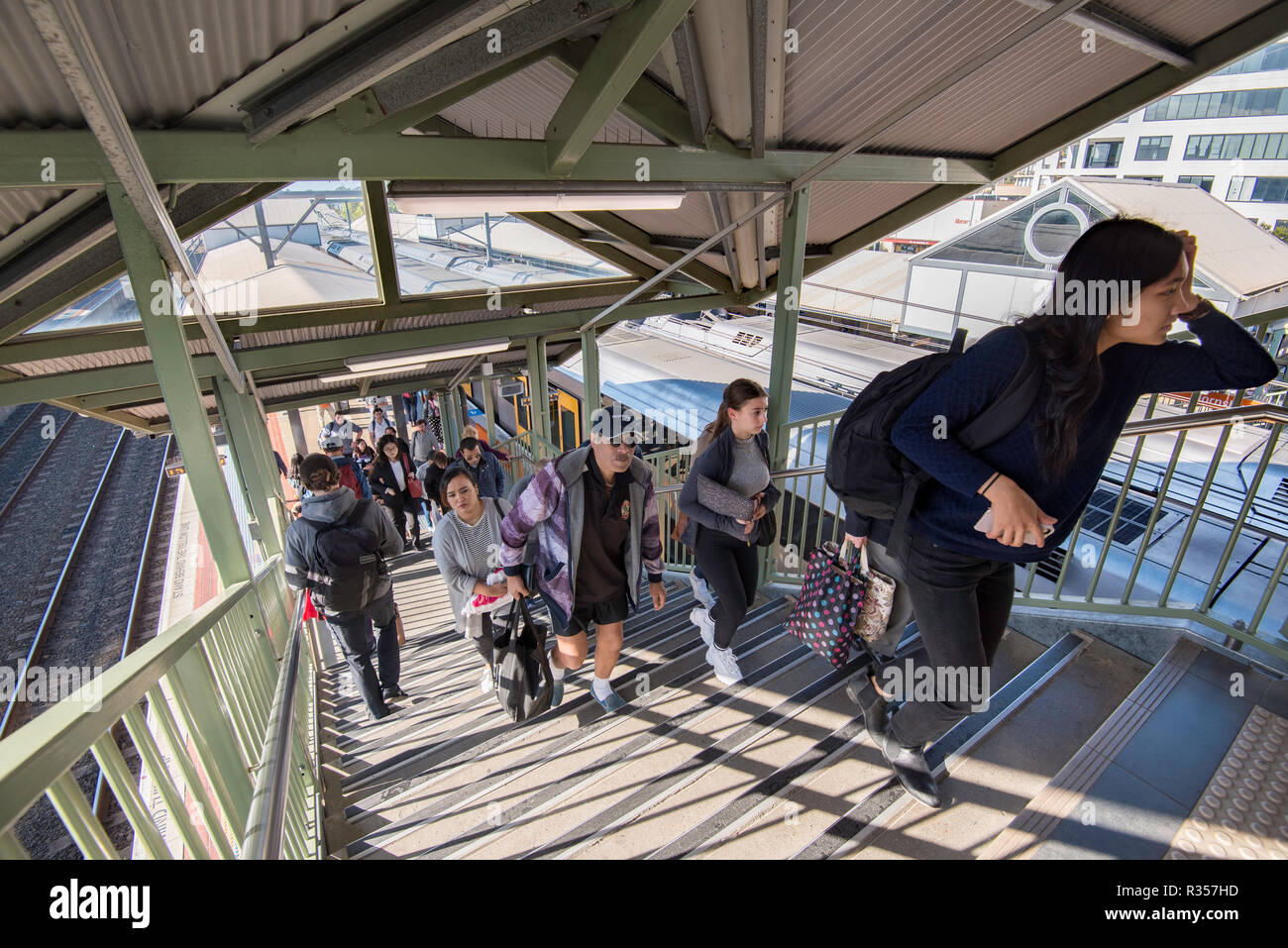 Rail passengers disembarking and walking up stairs hi-res stock ...