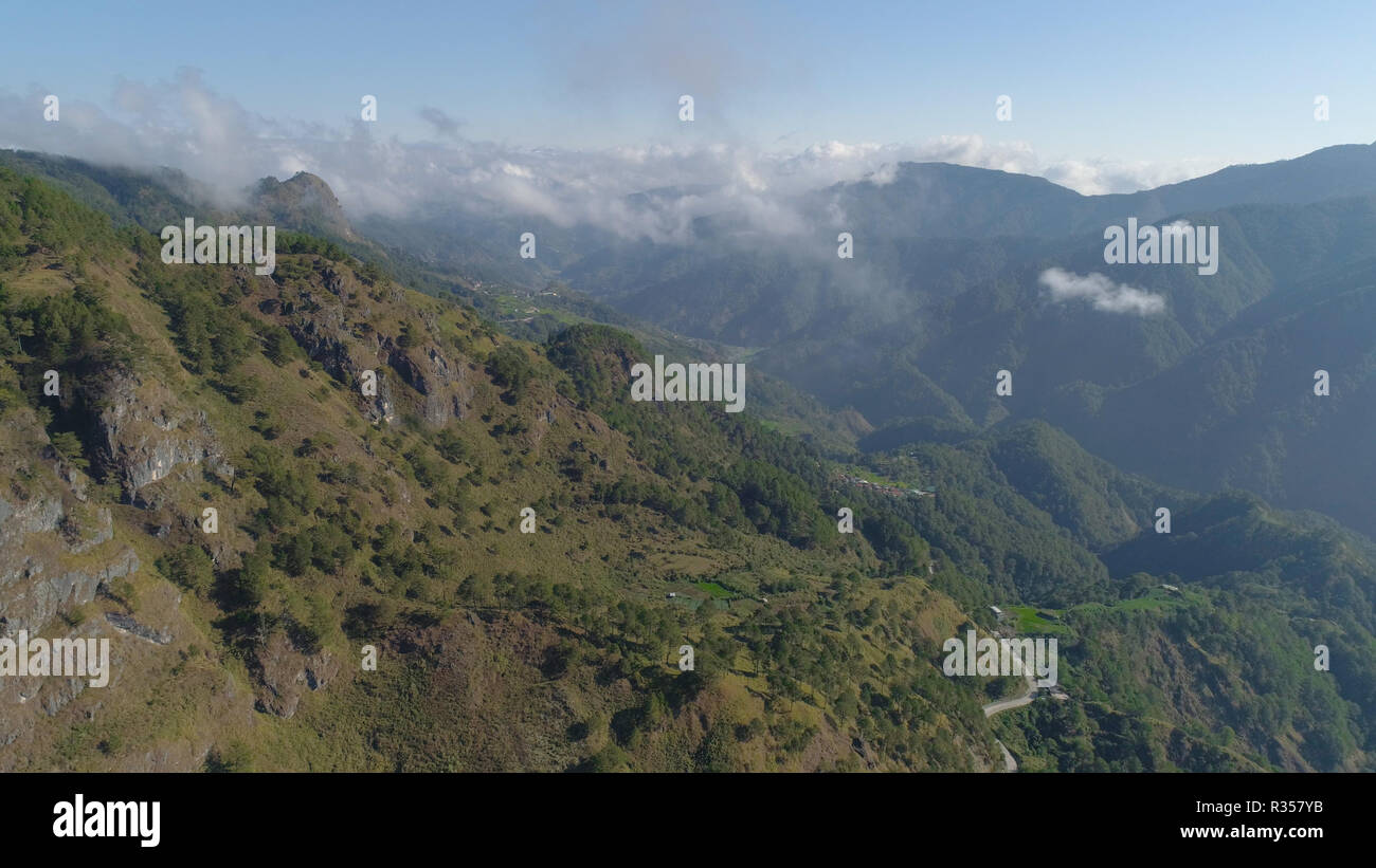 Aerial view of mountains covered forest, trees in clouds. Cordillera ...