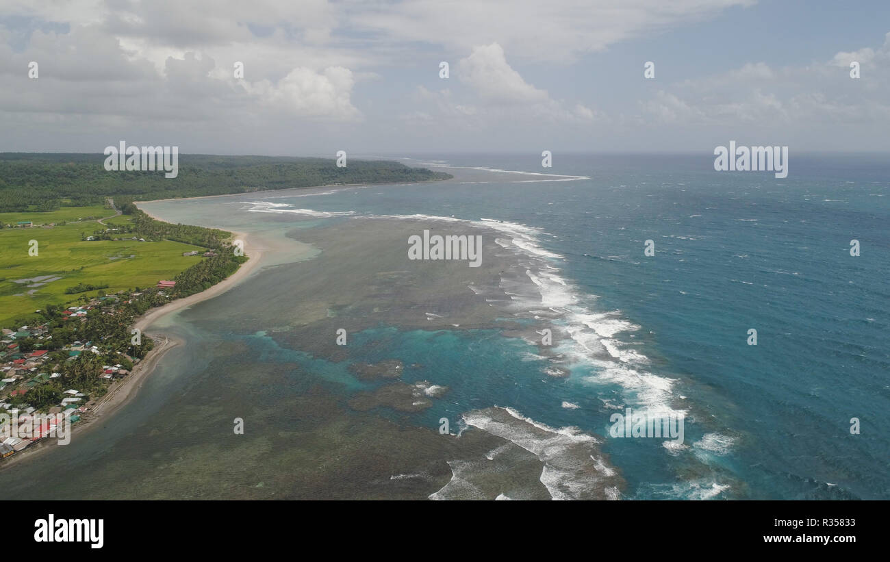 Aerial view of seashore with coastal town, beach, lagoons and coral ...